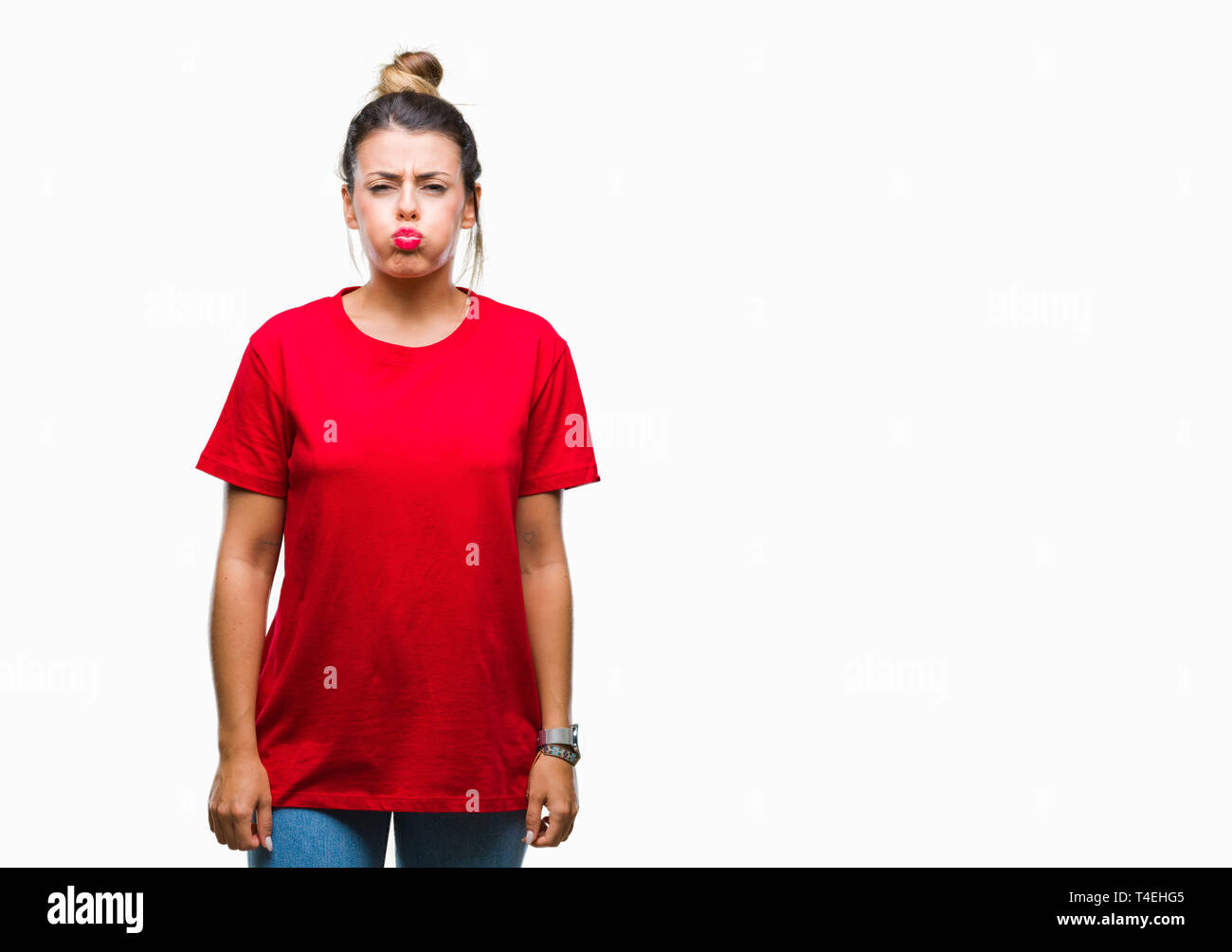 Young beautiful woman over isolated background puffing cheeks with ...