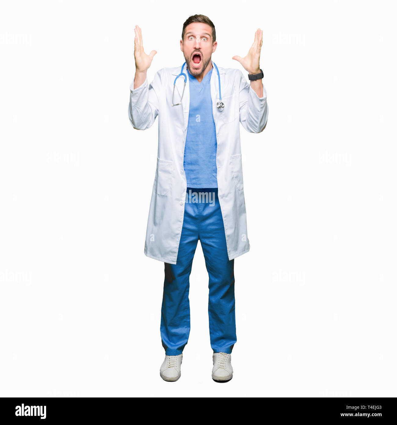 Handsome doctor man wearing medical uniform over isolated background ...