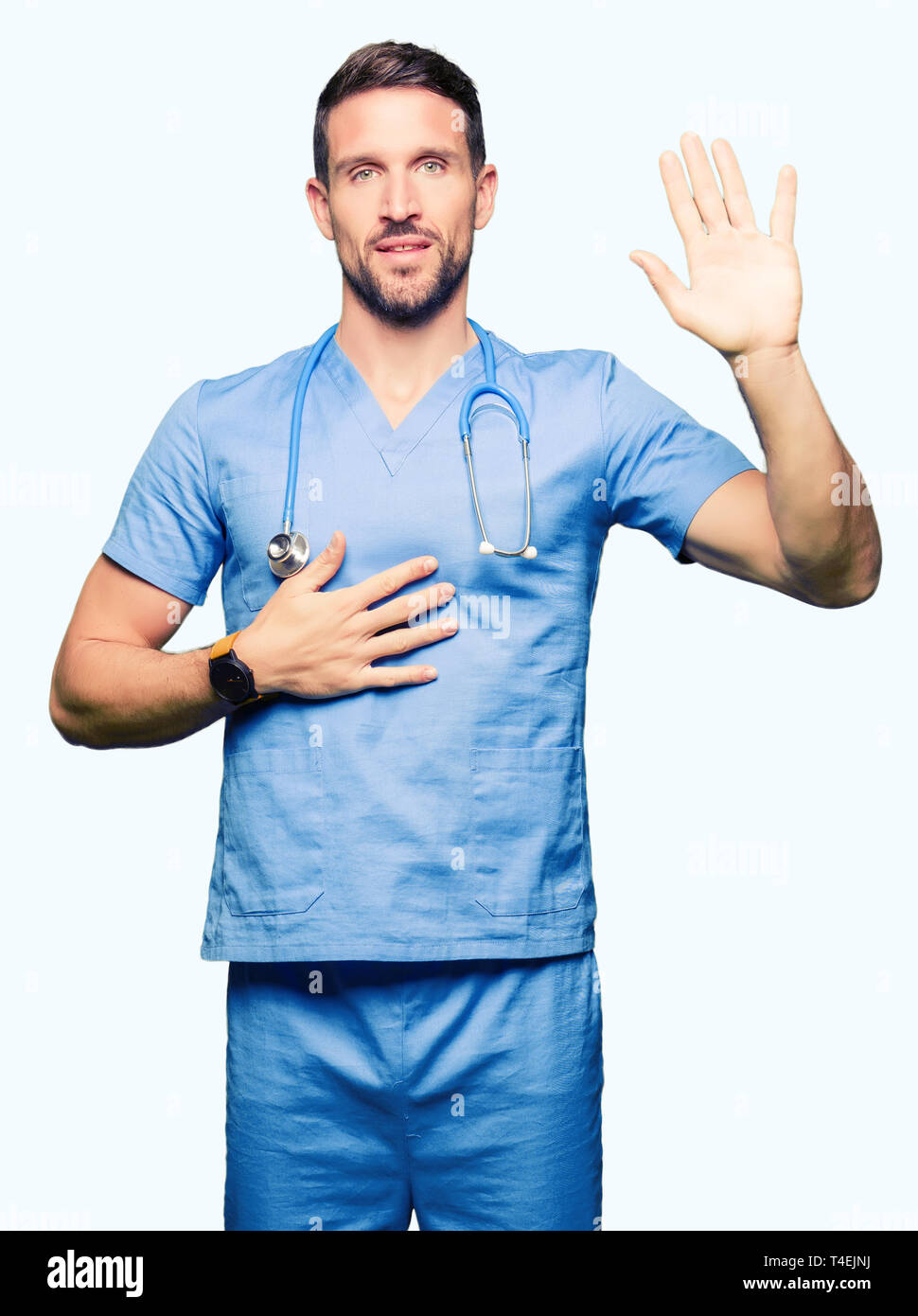 Handsome doctor man wearing medical uniform over isolated background ...