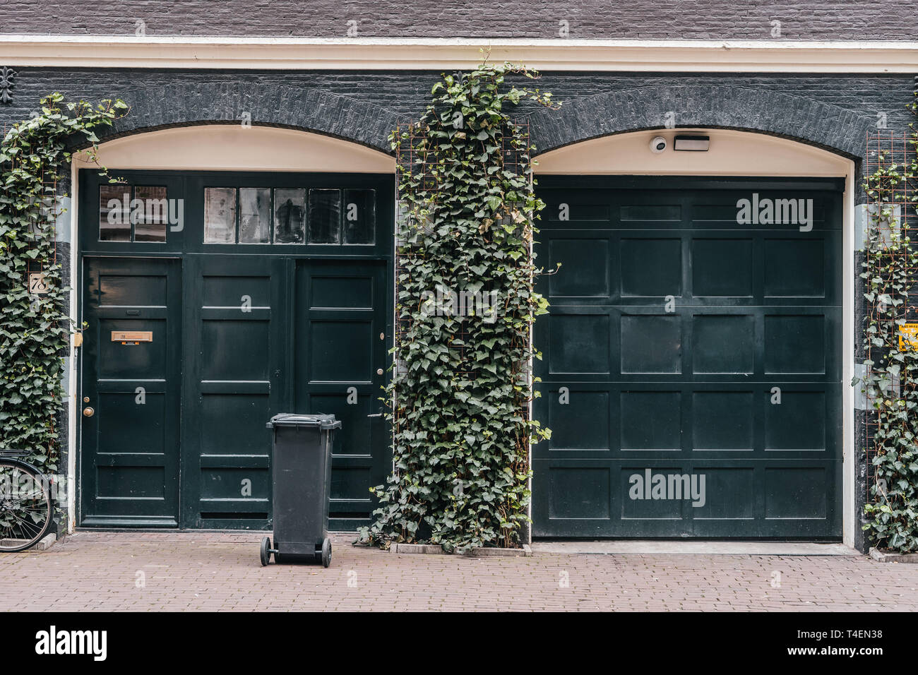Traditional european garage with black brick and dark gates Stock Photo ...