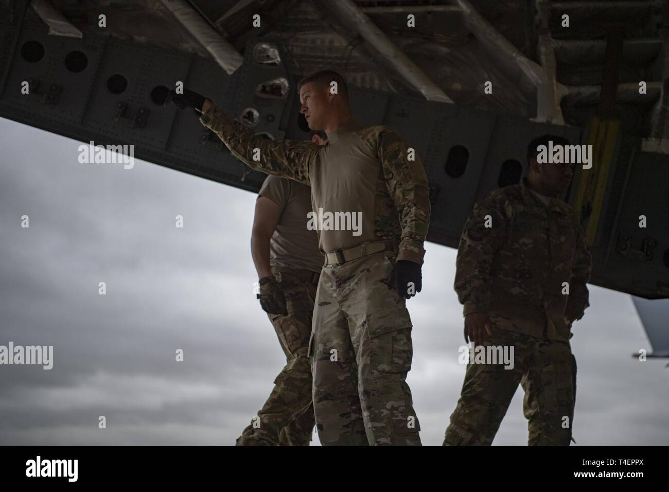 U.S. Air Force Master Sergeant Pat Wagnon directs a forklift driver to ...