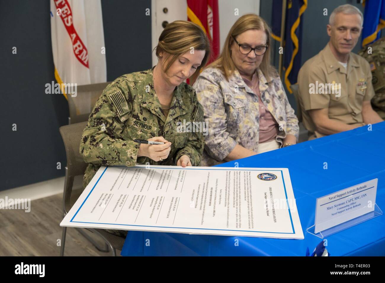 Capt. Mary Seymour, NSAB commanding officer, signs the installation's ...
