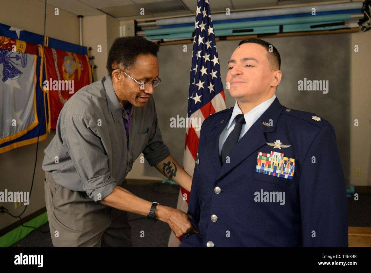 Dana Heard, 55th Wing Public Affairs photojournalist, adjusts the ...