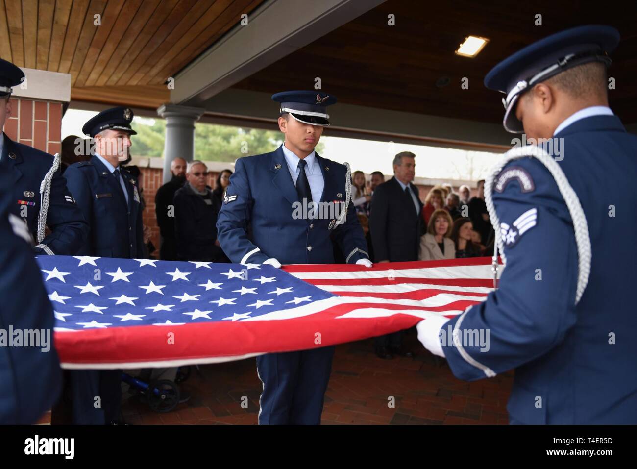 An Air Force Honor Guard team folds the American flag during the ...