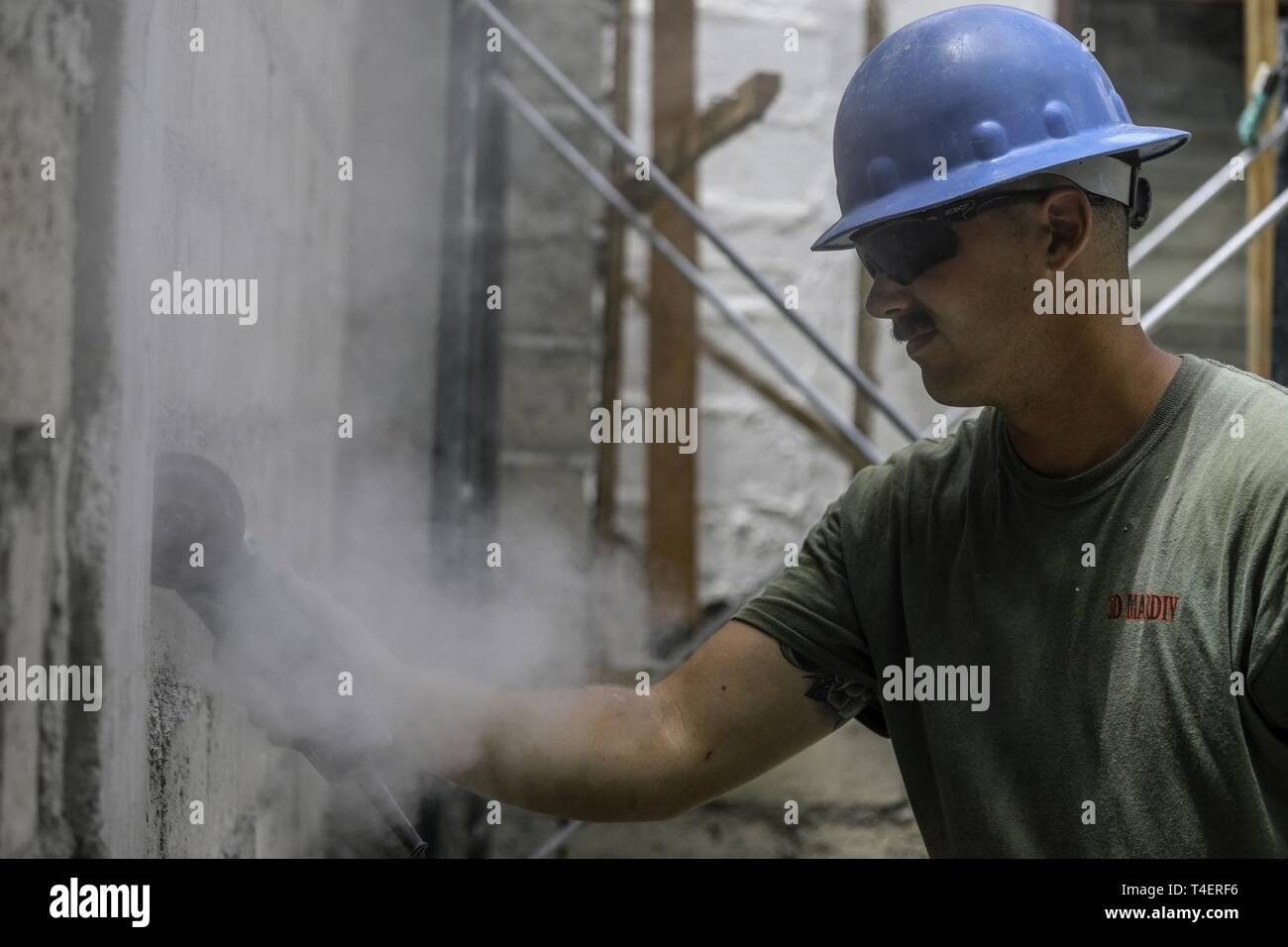 U.S. Marine Corps Cpl. Christian Gibbons grinds a passage for a ...