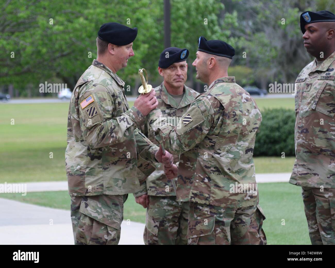 Command Sgt. Maj. Jospeh Krinsky symbolizes his relinquishment by ...