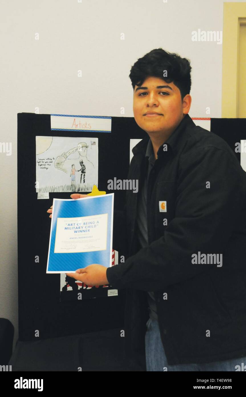 Angel Rodriguez, 16, stands next to his art at the Call for the Arts ...