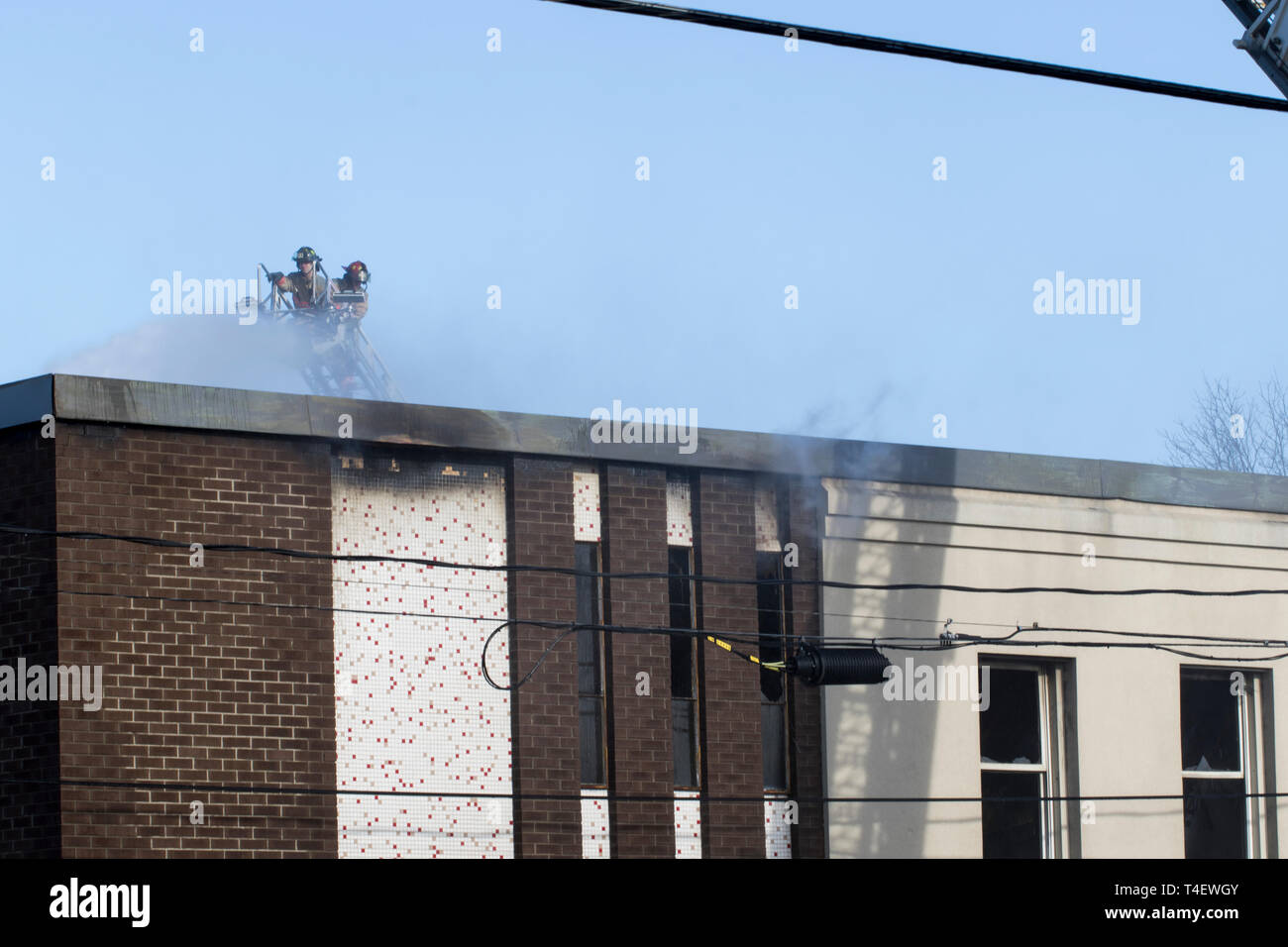Ontario Canada April 13 2019:Spraying down building on fire to contain ...