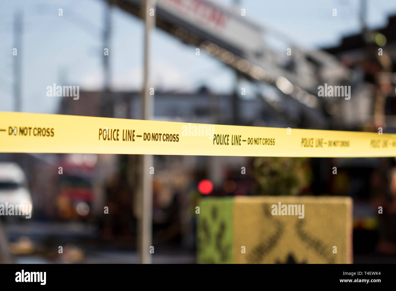 Police line do not cross. Yellow emergency tape at the scene of a fire ...