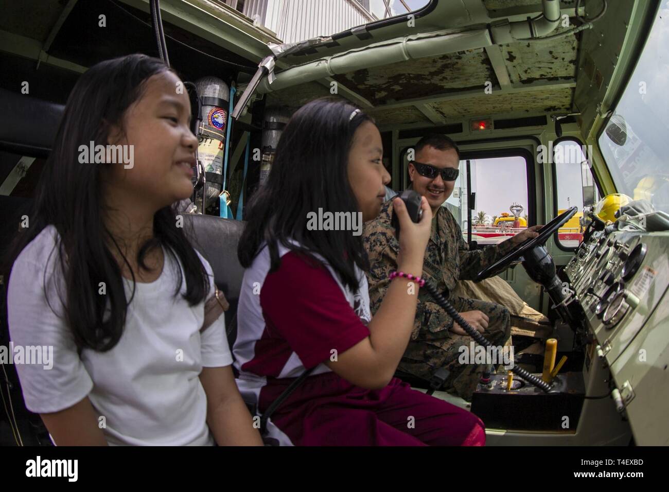 A student from Sapang Bato Elementary School uses an intercom system of an A/S32P-19A fire truck ...
