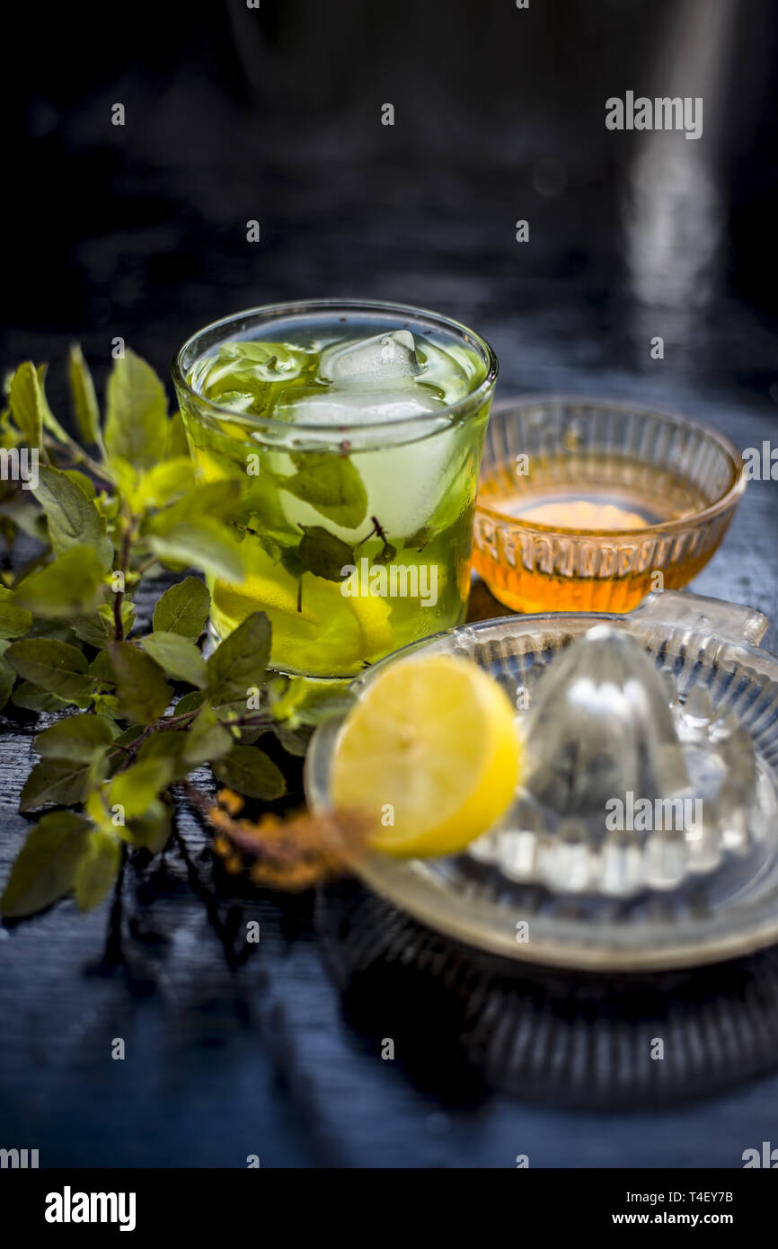 Close up of Herabal drink or Basil lemonade in a transparent glass with ...