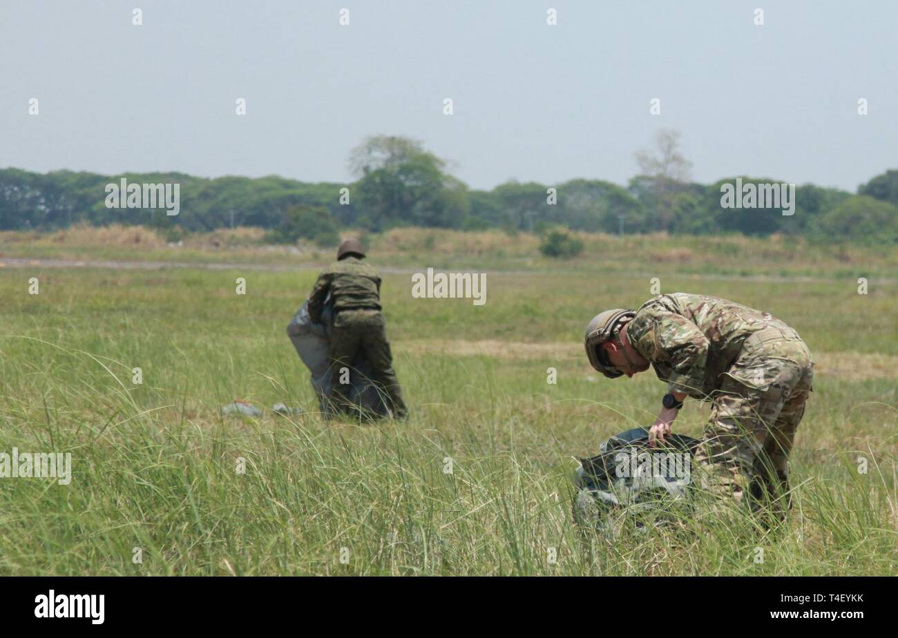 A U.S. Special Forces Soldier and a Philippine Army Soldier collect ...