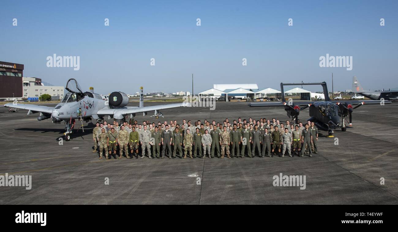 U.S. and Philippine Air Force pilots and maintenance personnel pose for a group photo in front ...