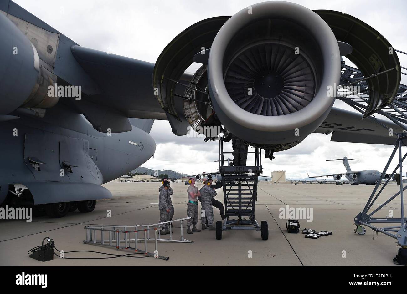 Several crew chiefs from the 62nd Aircraft Maintenance Squadron work to ...