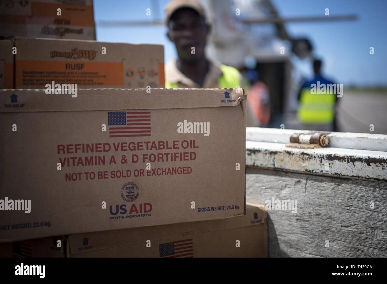 Boxes containing vegetable oil sit in stacks before being loaded on a ...