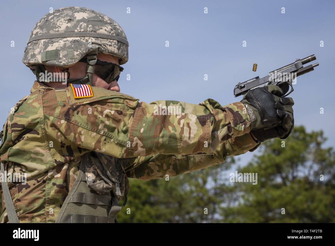 U.S. Army Pfc. Matthew D. Maher, Medical Detachment, fires an M9 pistol ...