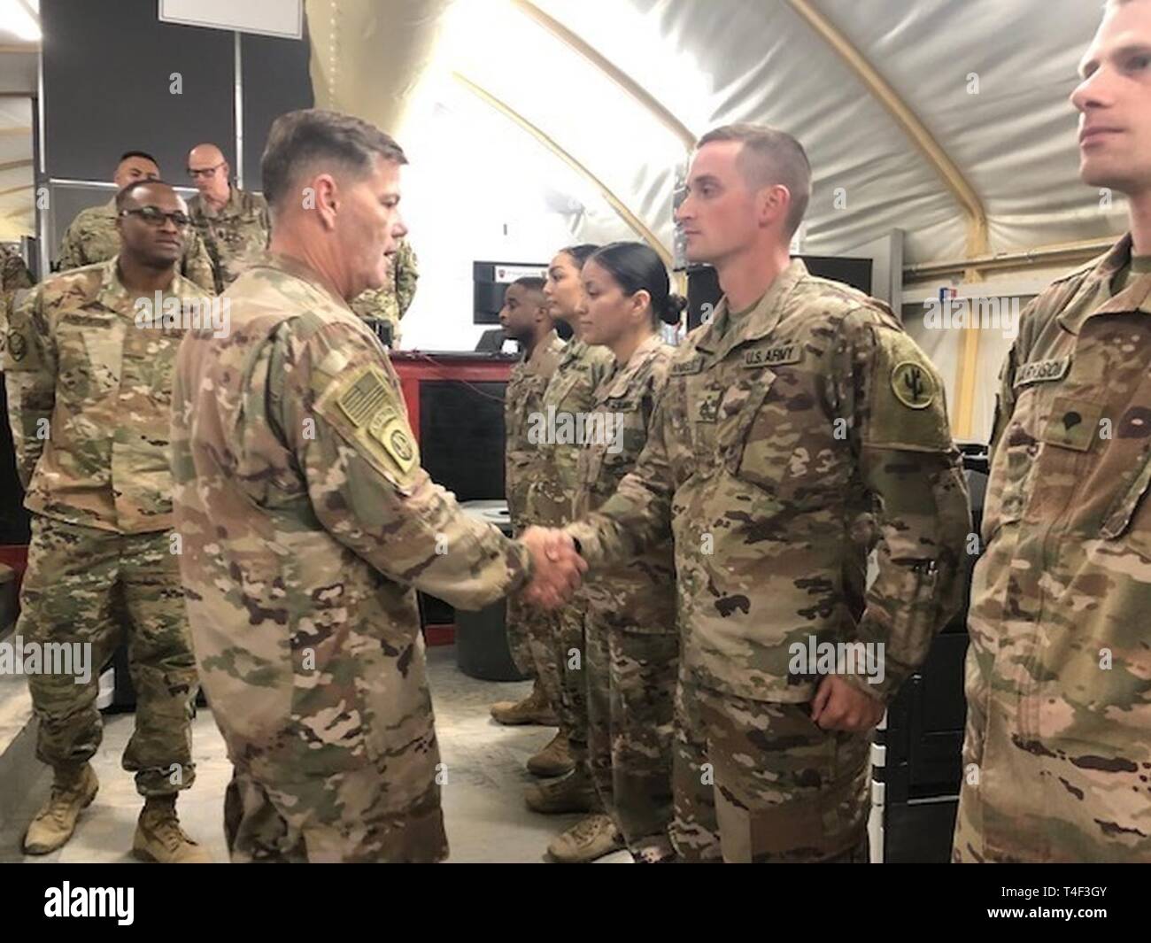 Sgt. Cory Knisely, 657th Movement Control Team, receives a command coin ...