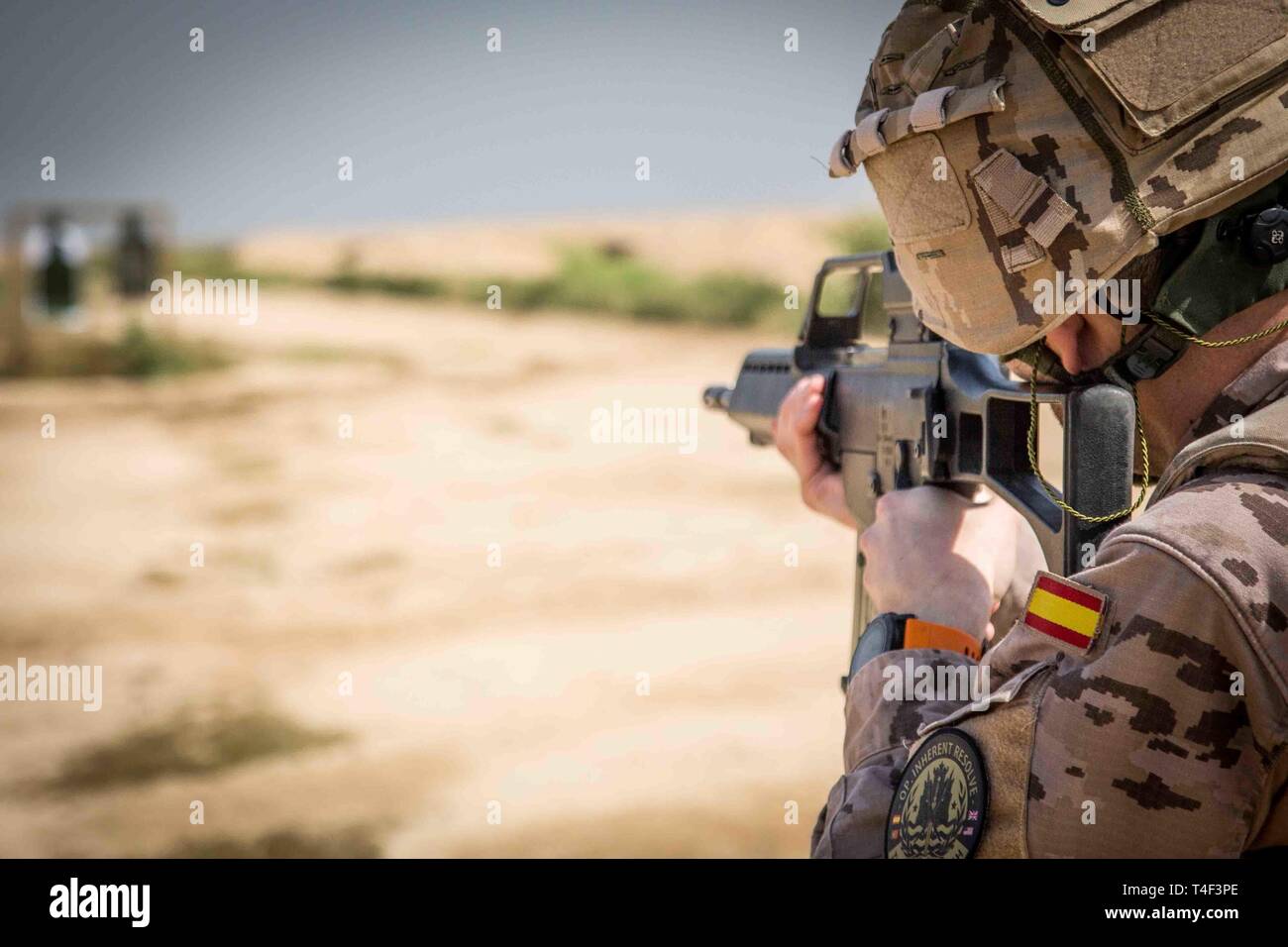 A Spanish Soldier aims a HK-G36 assault rifle at the Besmaya Range ...
