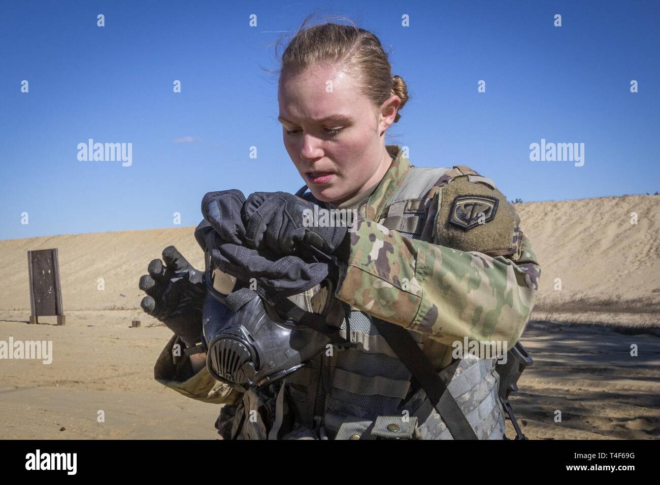 U.S. Army Spc. Emma E. Archut, 328th Military Police Company, dons her ...