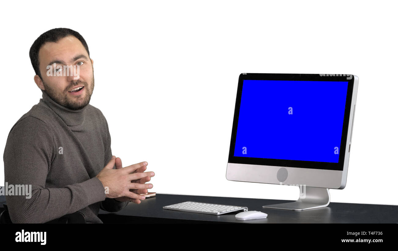 Casual businessman smiling and talking at the camera showing something ...