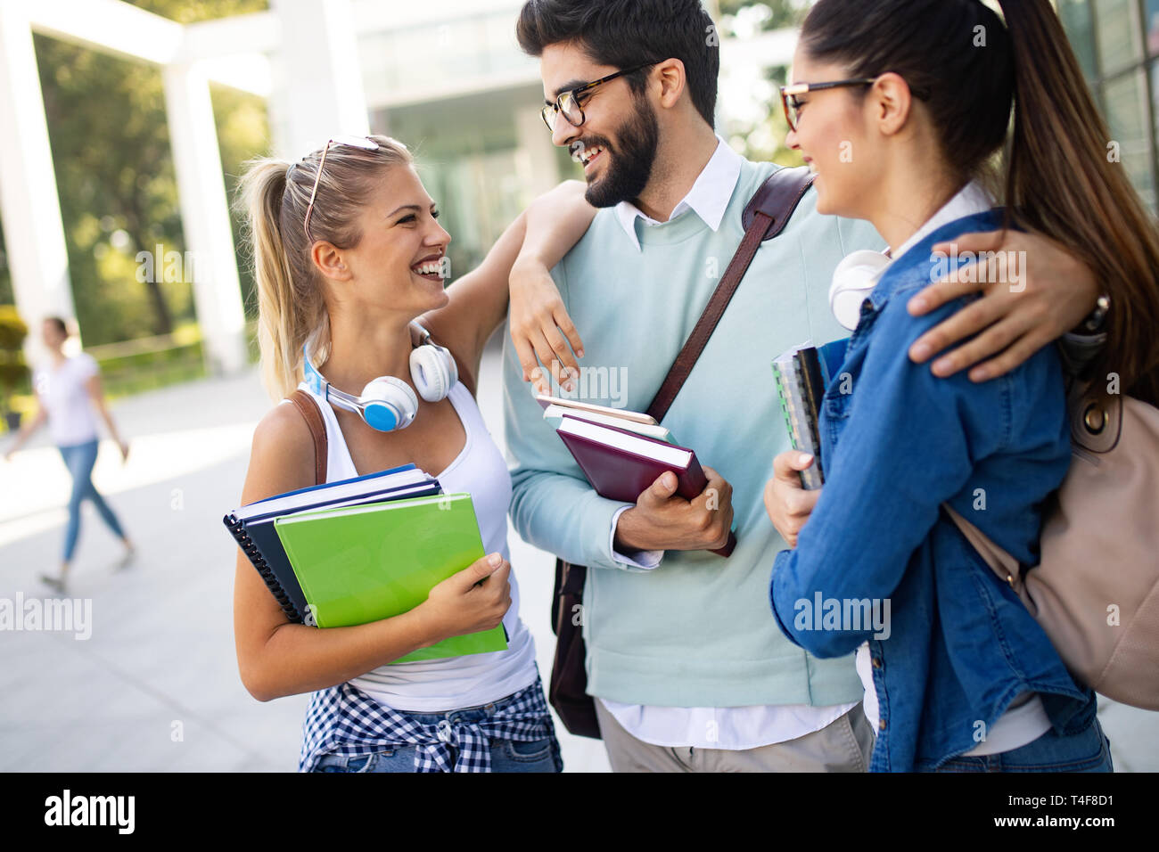 Happy university friends studying together in college Stock Photo - Alamy