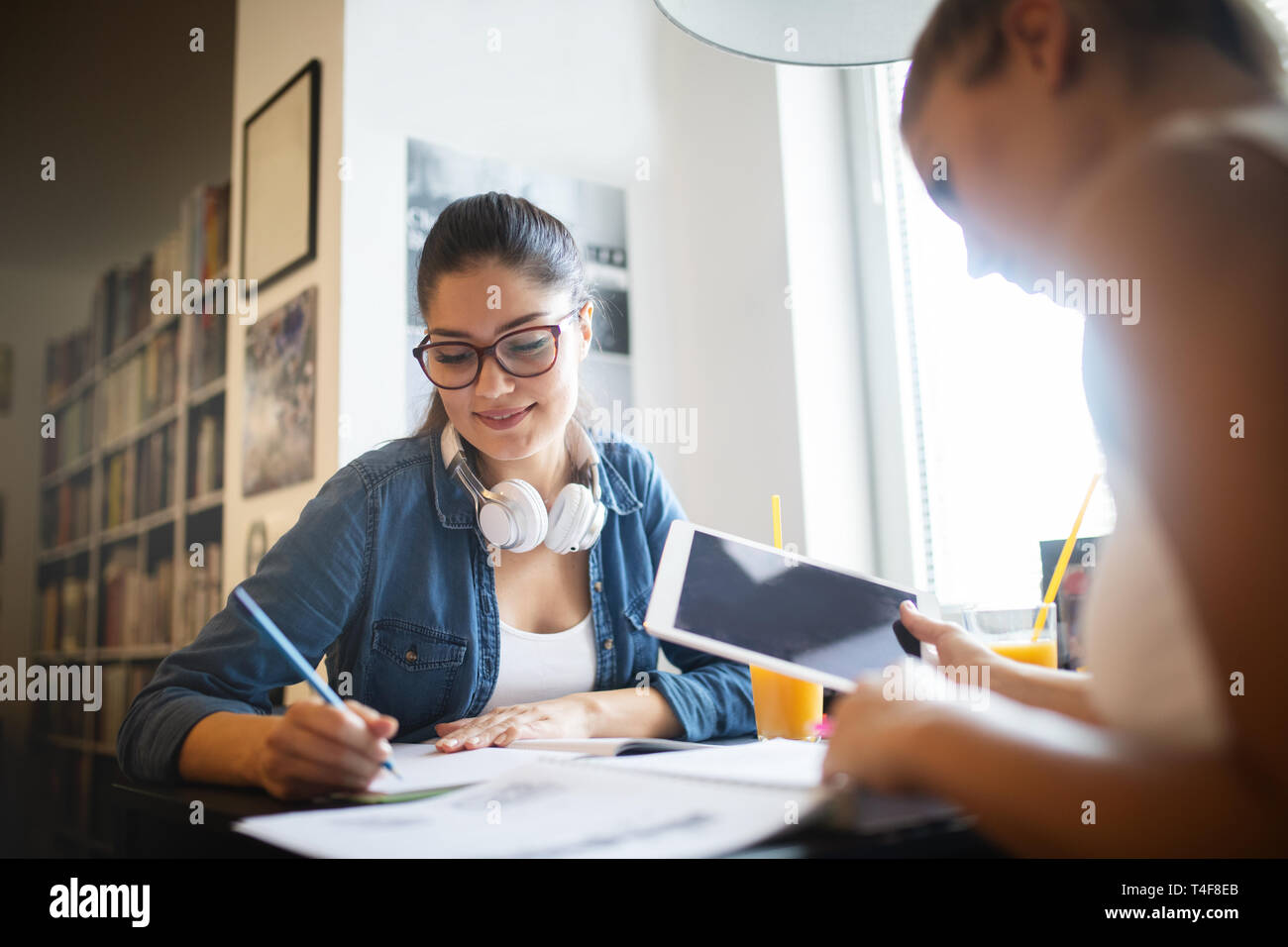 Happy university friends studying together in college Stock Photo - Alamy