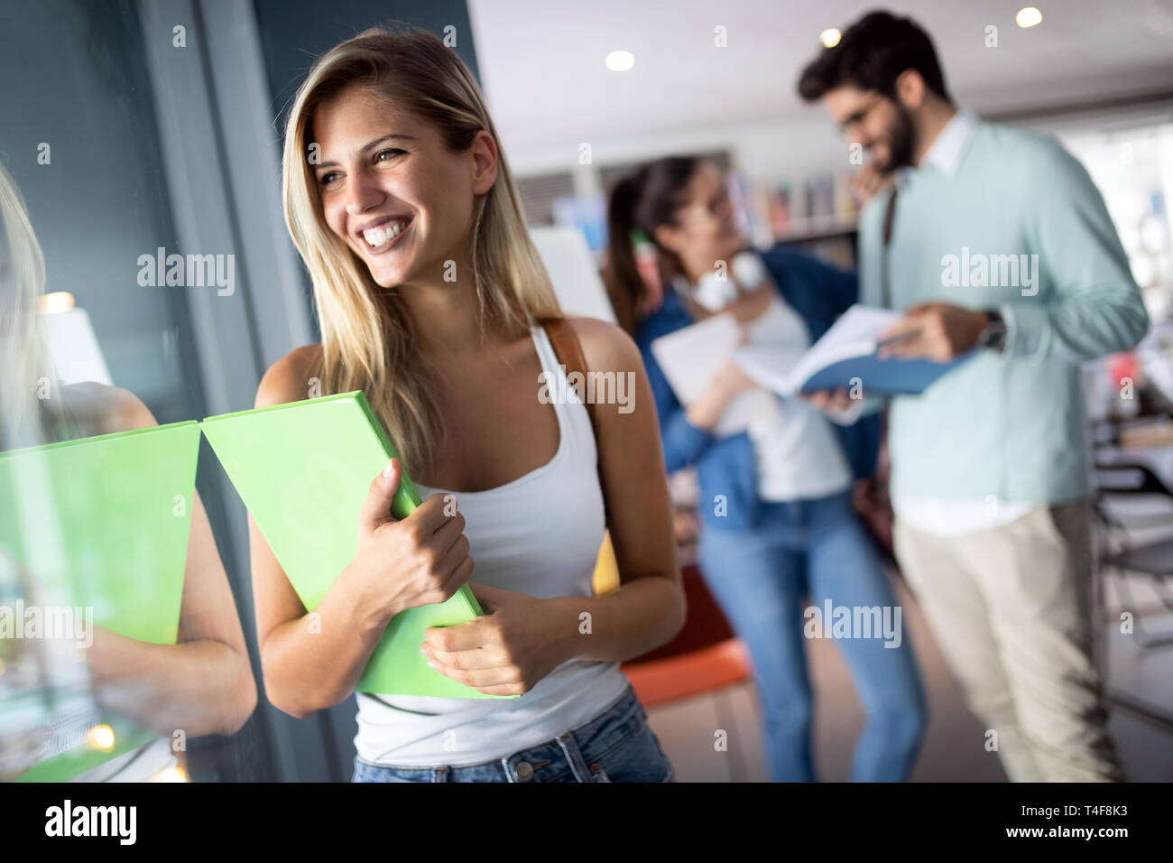 Happy group of friends studying and talking together at university ...