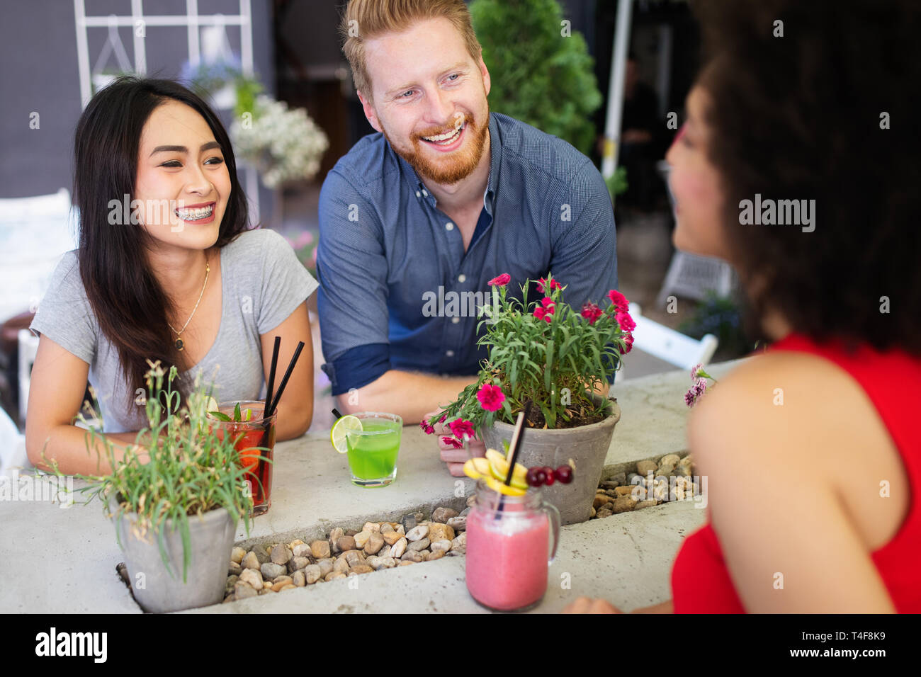 Multiracial group of friends having fun and talking Stock Photo - Alamy