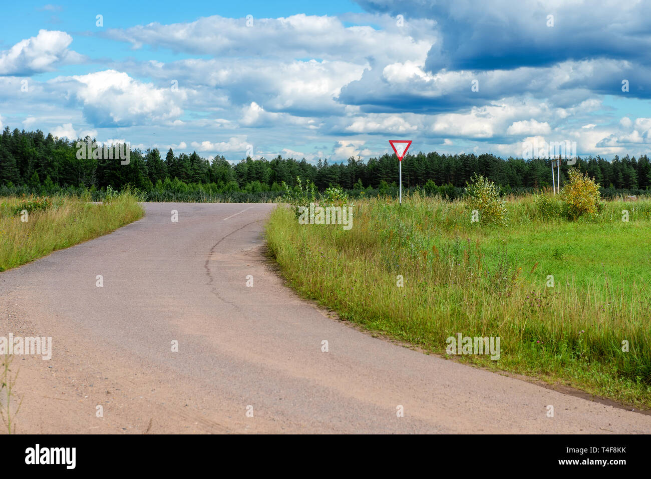 Asphalt country road to the intersection Stock Photo - Alamy