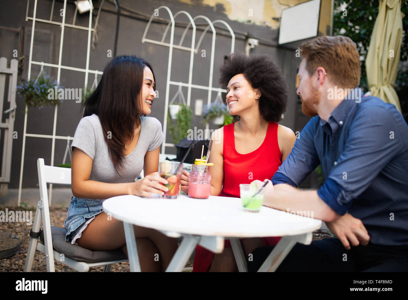 Multiracial group of friends having fun and talking Stock Photo - Alamy