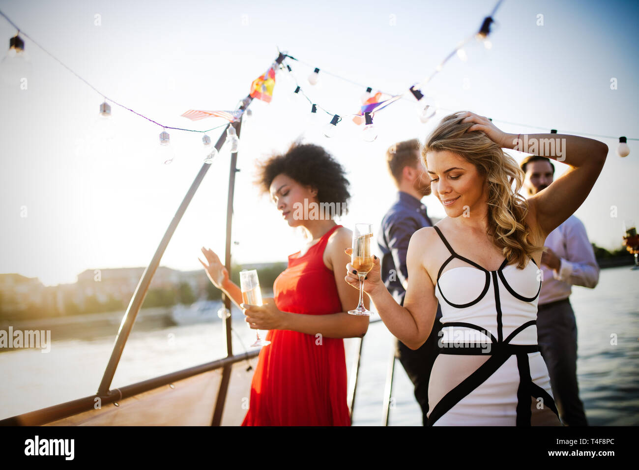 Group of friends drinking, chatting and having a fun at outdoor party ...