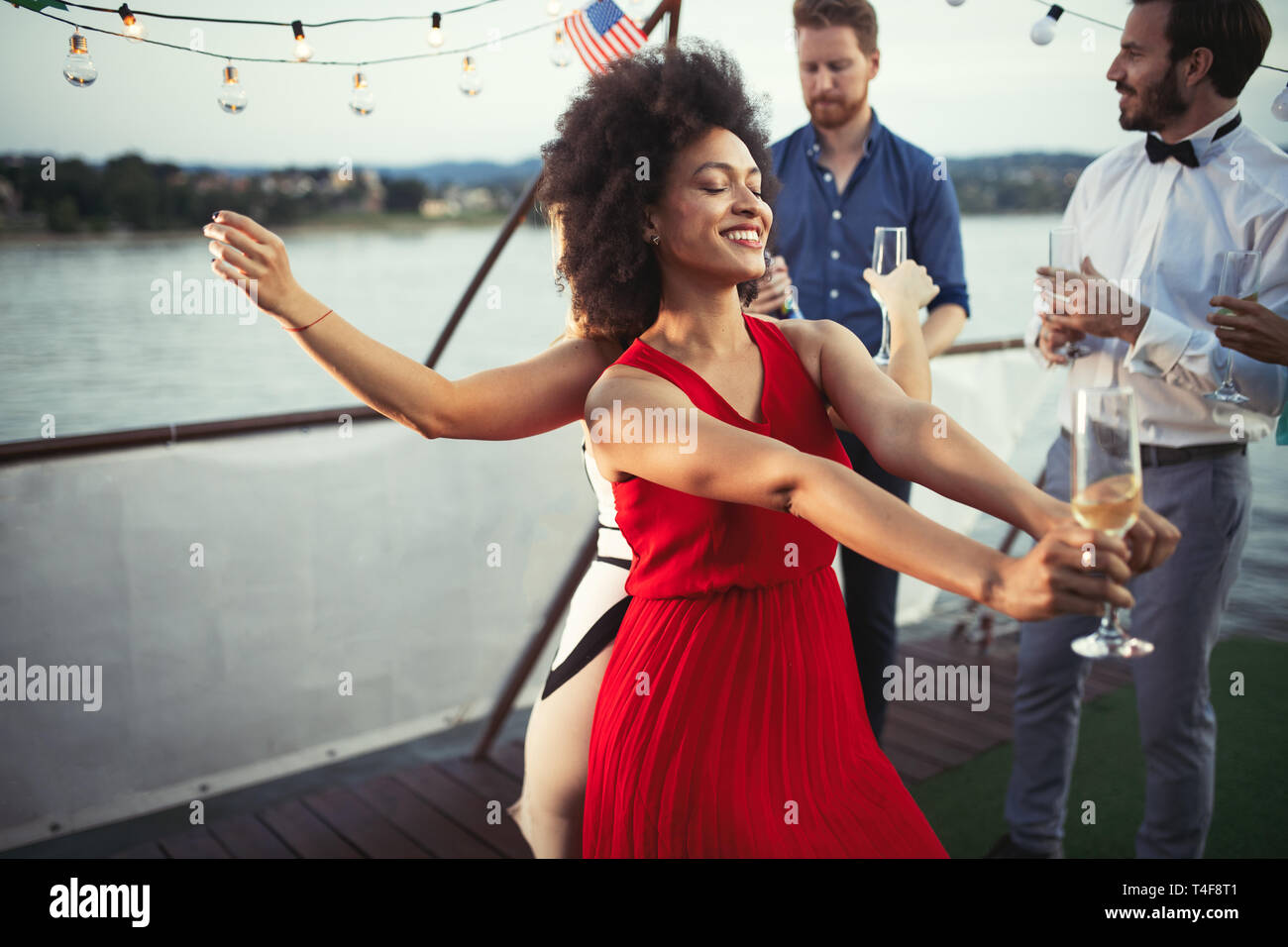 Group of friends at party dancing and smiling together Stock Photo - Alamy