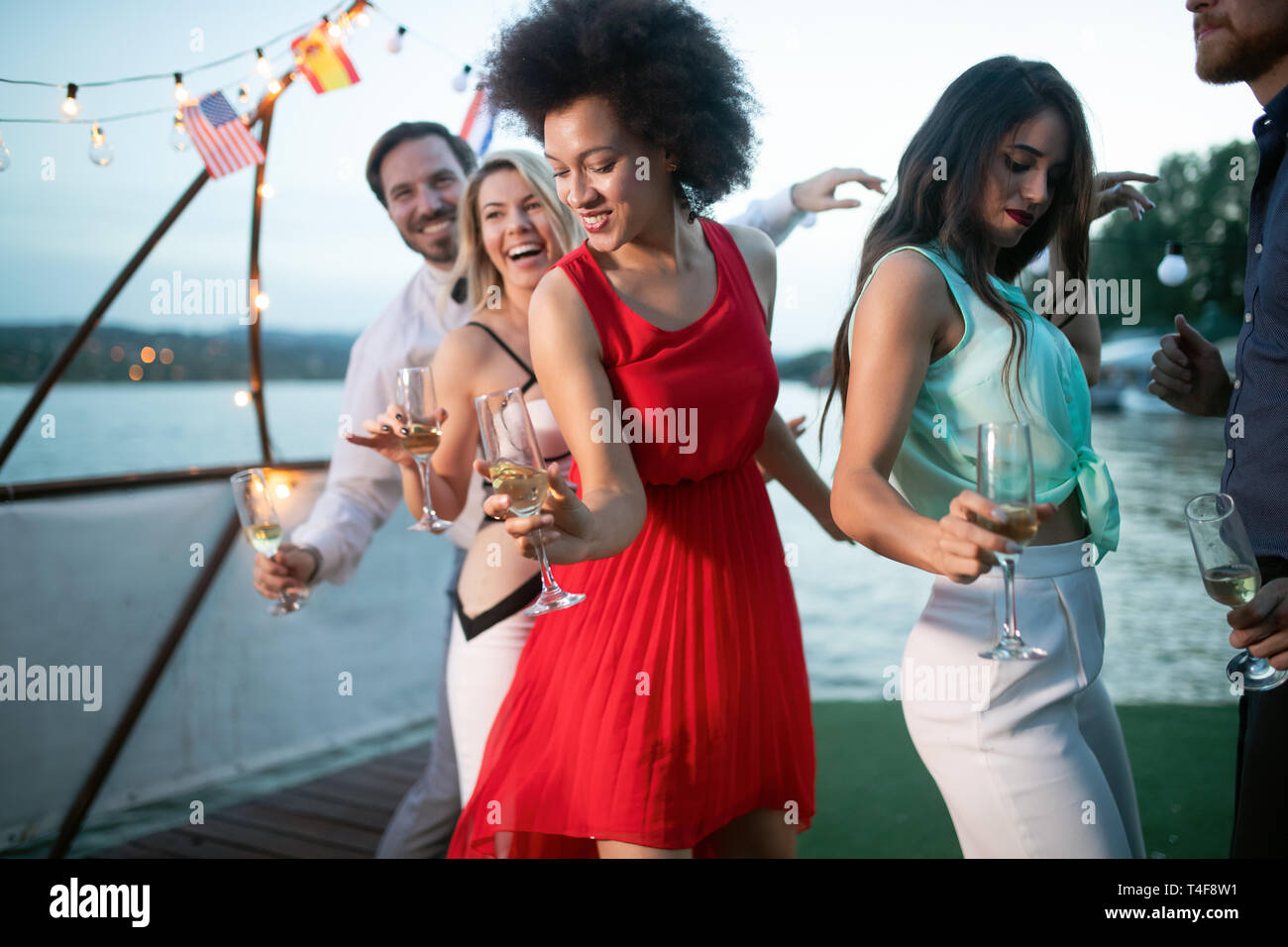 Group of friends at party dancing and smiling together Stock Photo - Alamy