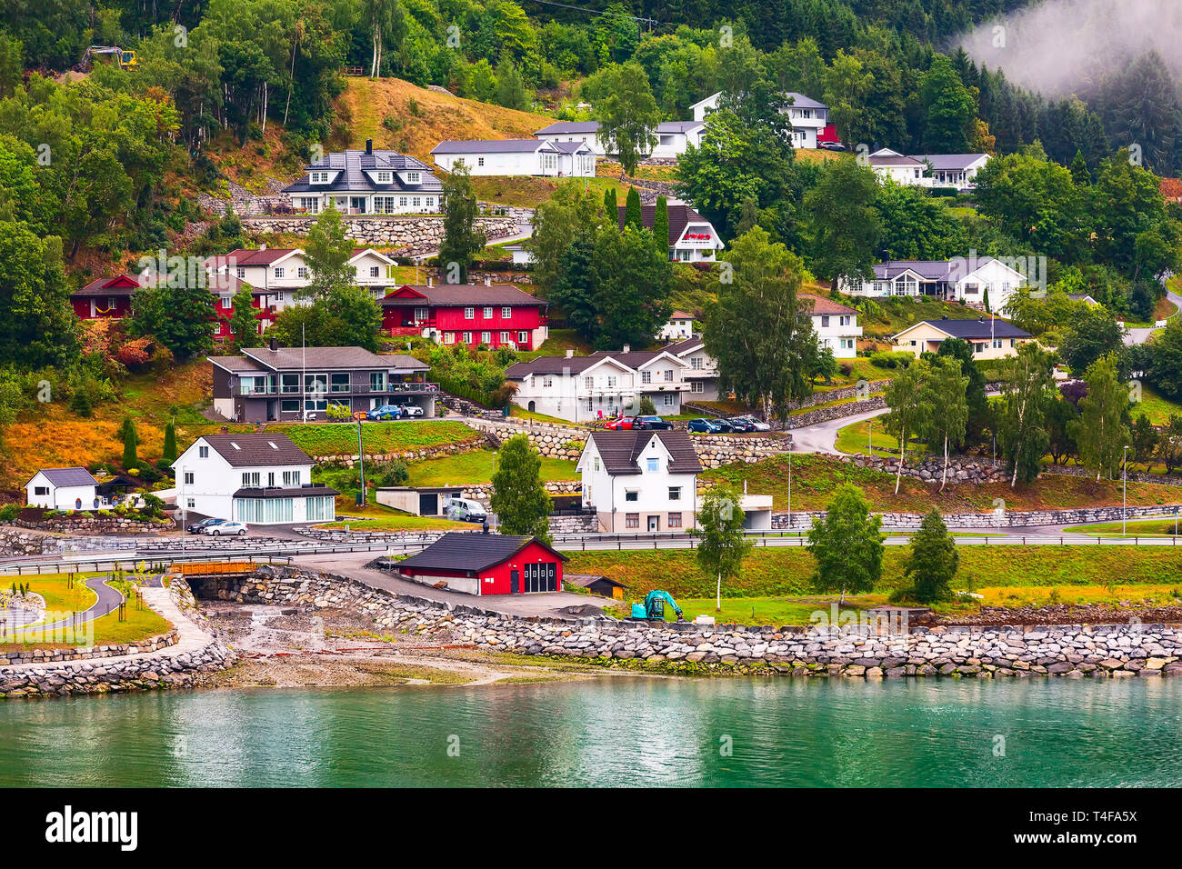 Norwegian fjord village landscape with low fog clouds, mountains and ...