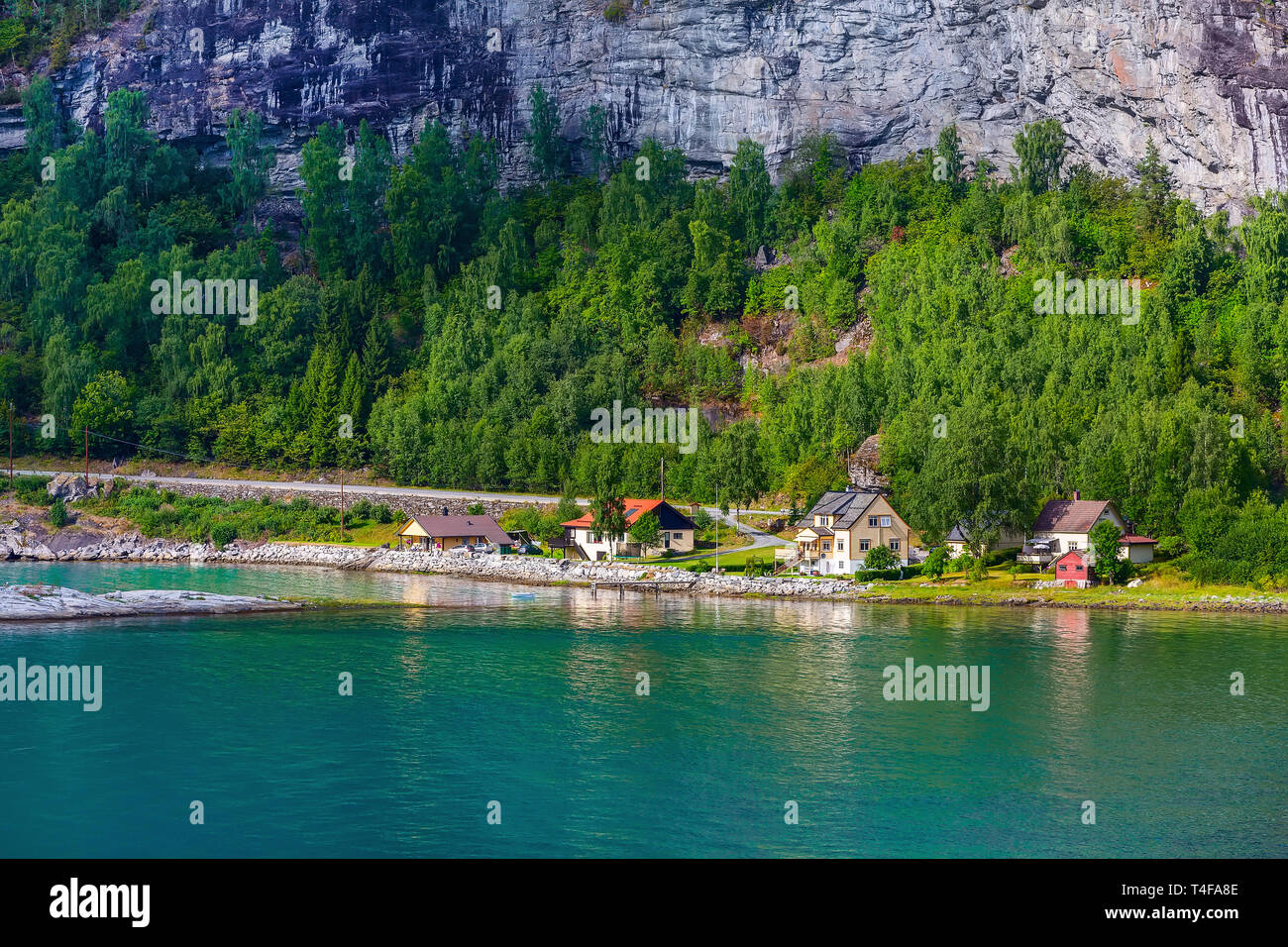 Norwegian village landscape with fjord, mountains and colorful houses ...
