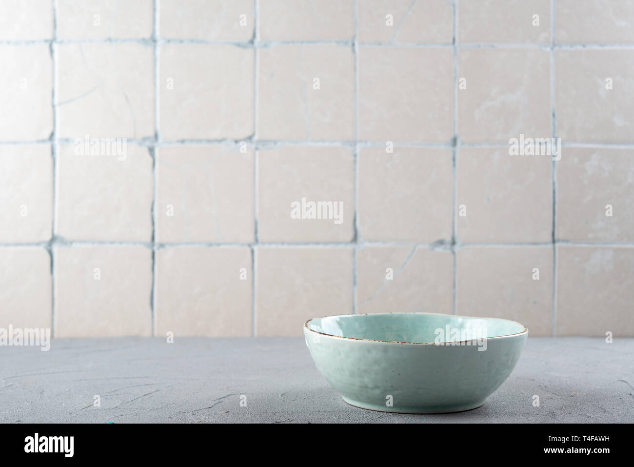 Blue bowl on kitchen background with ceramic tiles Stock Photo - Alamy