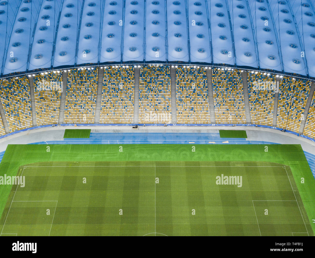 Aerial view from the drone to the football stadium with the blue-yellow ...