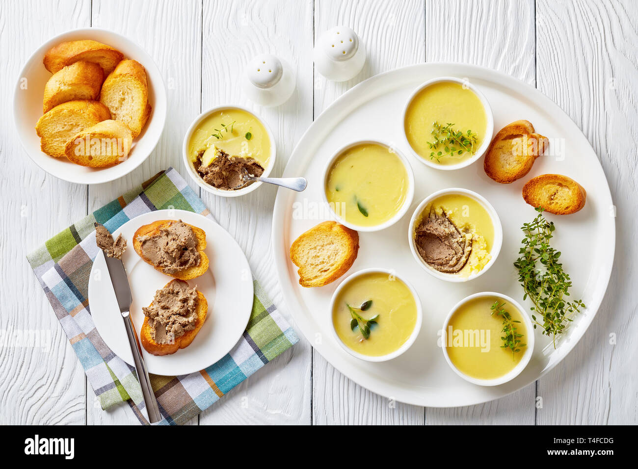 delicious poultry liver pate with herbs and butter in ramekins on a ...