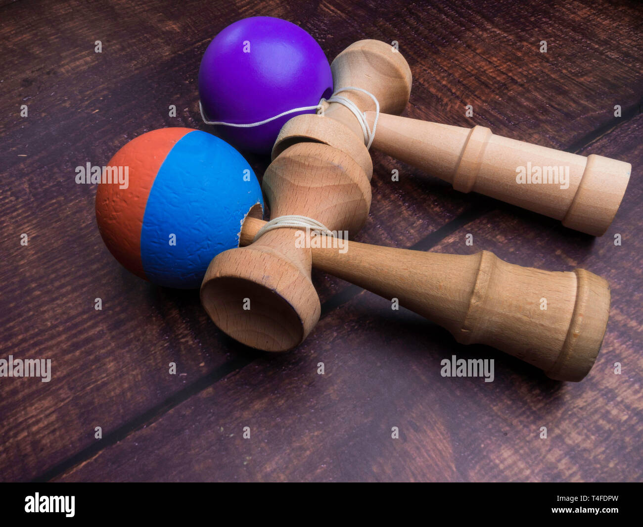 Classic Japanese game kendama on wooden background. Two playing ...
