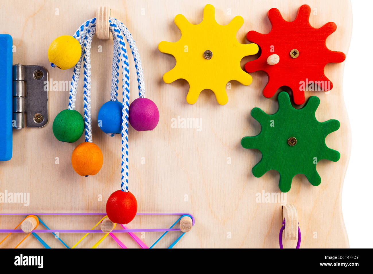 Close-up of laces with beads and gears on a wooden busy board ...
