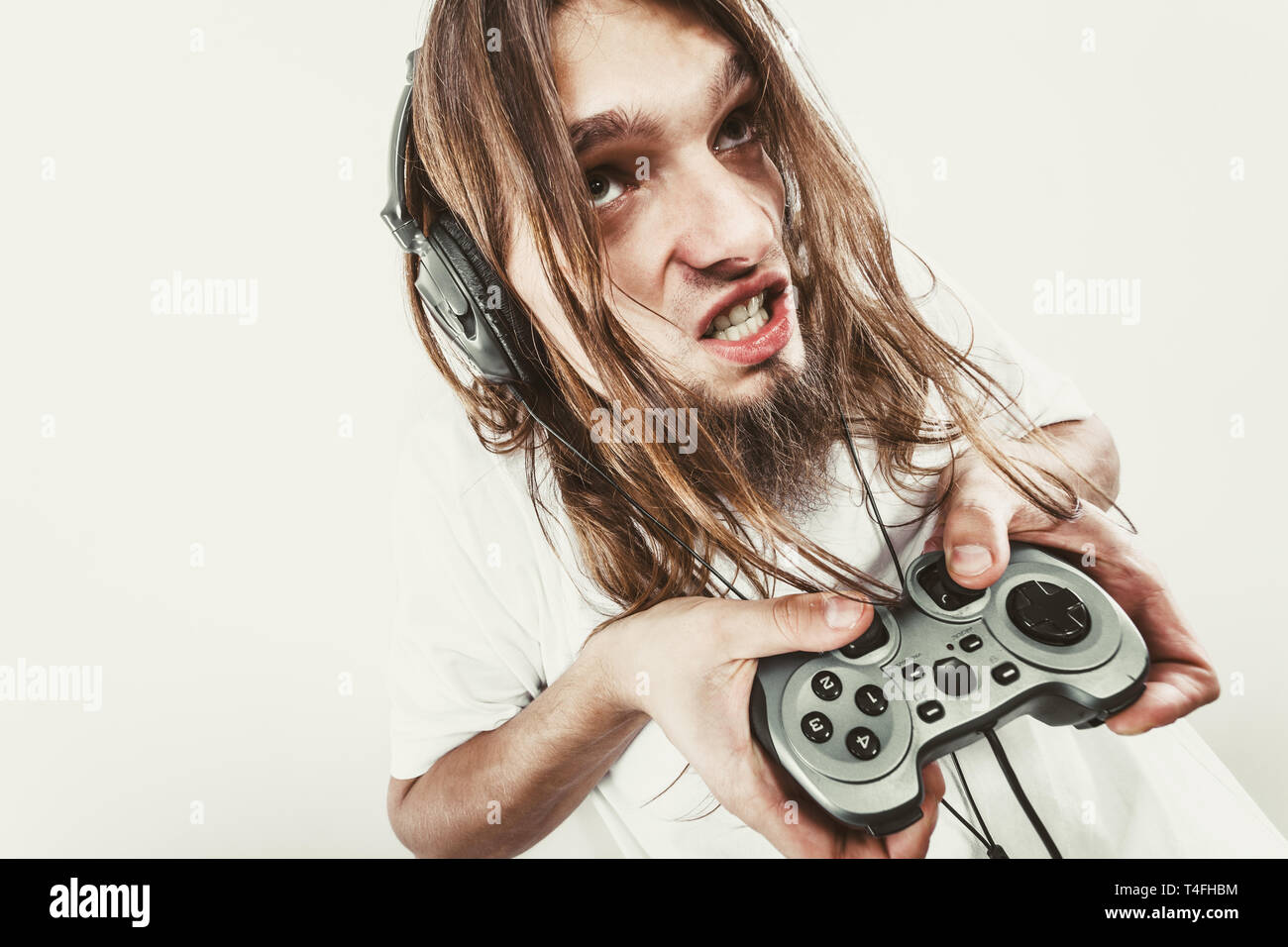 Addiction. Stressed depressed young man playing gaming on pad. Angry ...