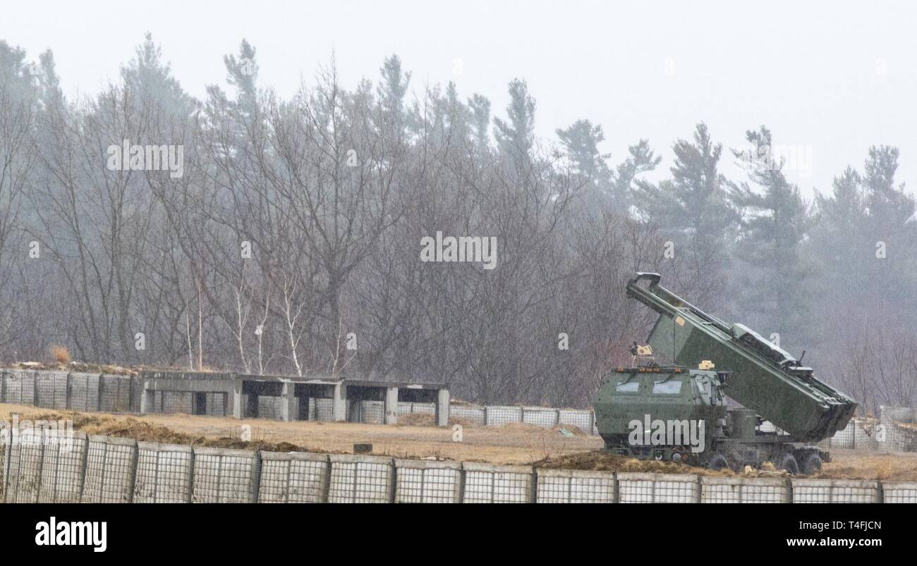Soldiers prepare to fire the M142 High Mobility Artillery Rocket System ...