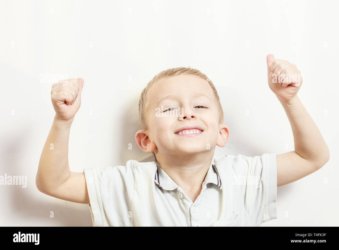 Free time, fun and expression. Little boy play indoors make silly ...