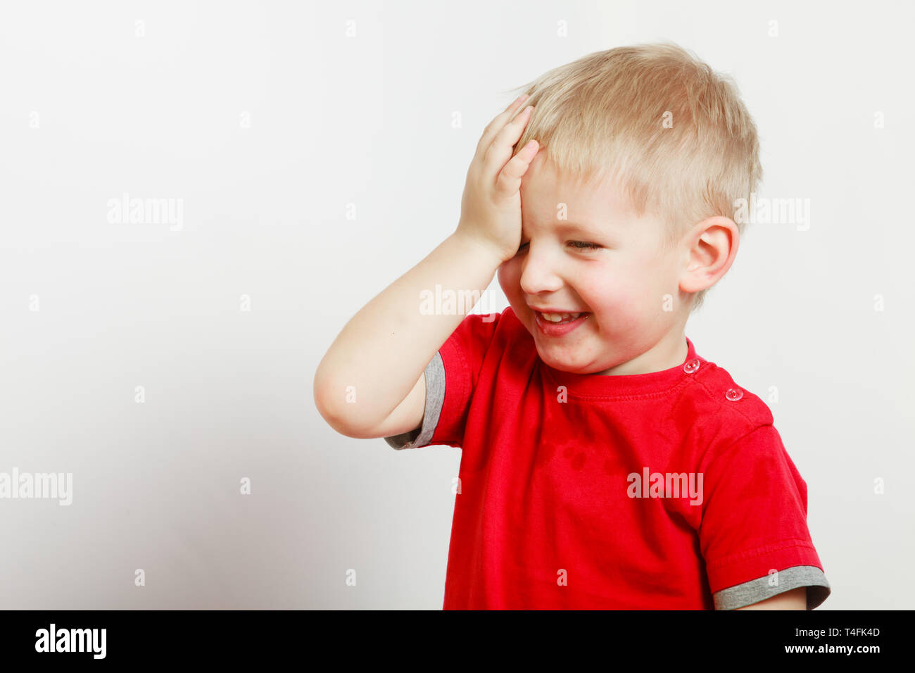 Face expressions, children concept. Portrait of happy kid boy making ...