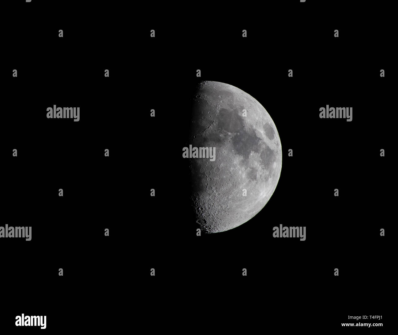 A clear shot of a half moon over Reading Stock Photo - Alamy