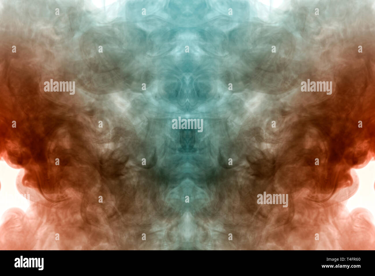 Mystical pattern of orange and blue colored smoke in the shape of a ...