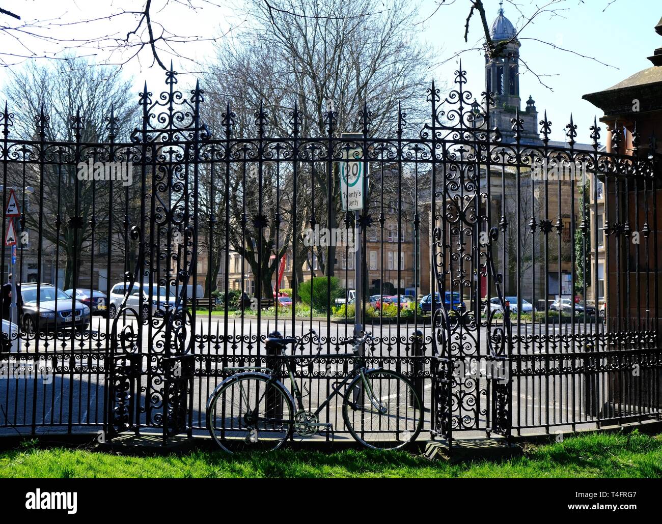 Bike resting against gate Stock Photo - Alamy