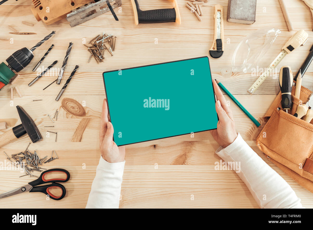 Female carpenter using digital tablet computer in woodwork workshop ...