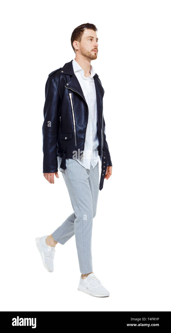 Front view of going handsome man in a leather jacket and trousers ...