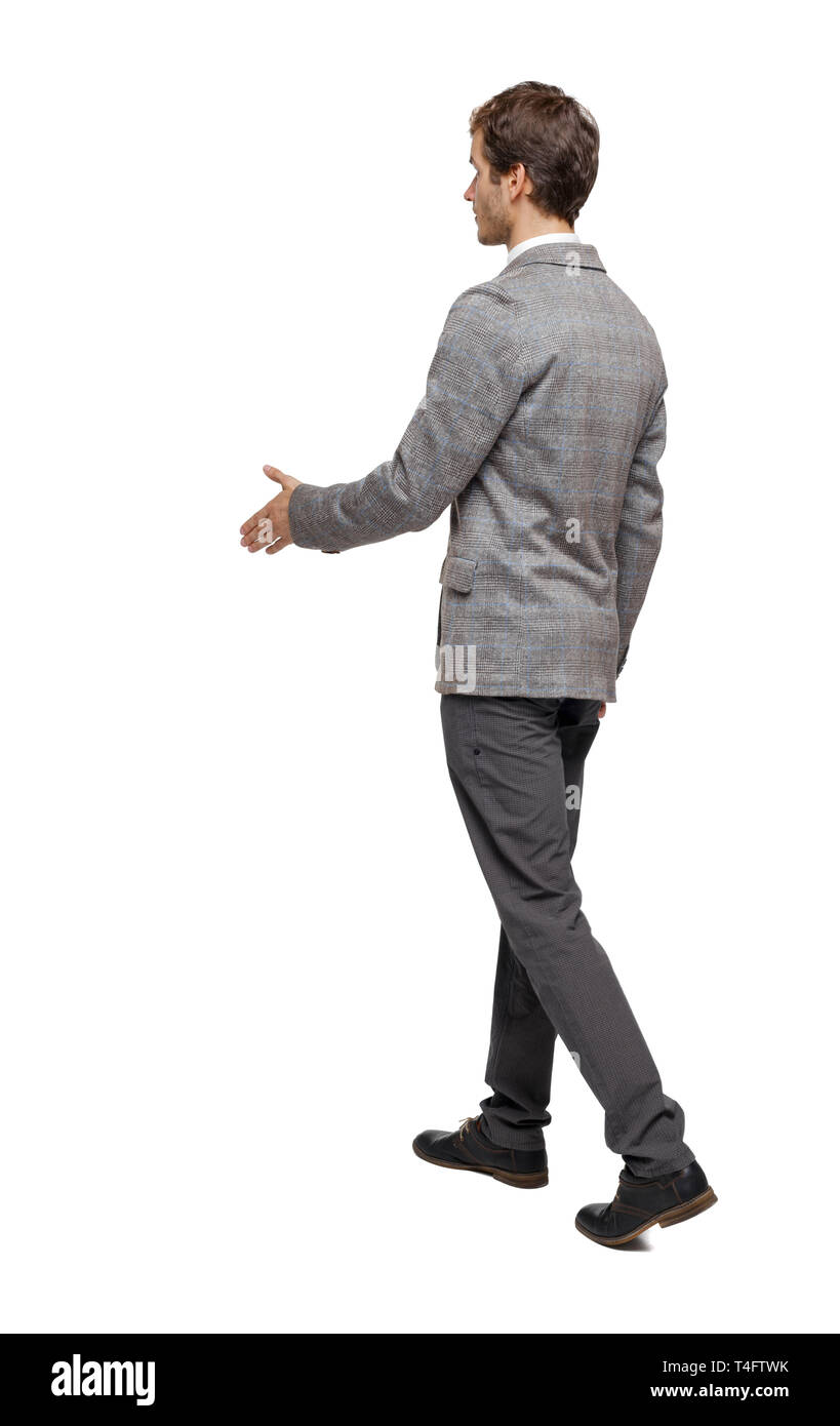 Back view of a walking businessman who stretches his hand for a ...